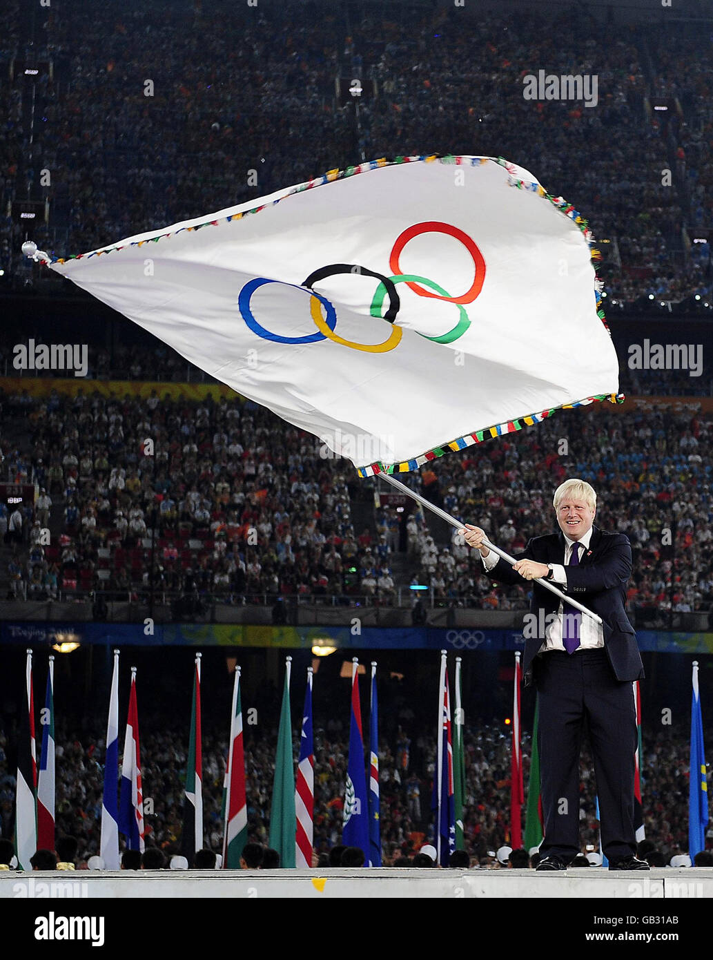 Mayor of London Boris Johnson waves the Olympic Flag during the ...