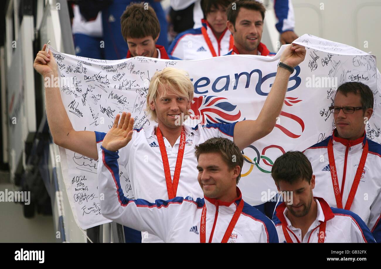 Gold medal winner Andy Triggs-Hodge leaves the plane carrying the Great ...