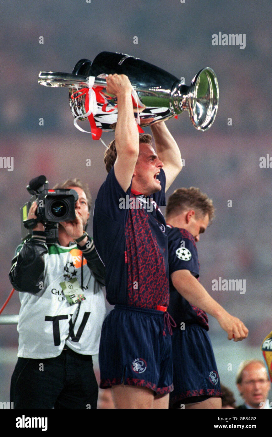 (L-R) Ajax's Ronald de Boer celebrates with the European Cup as his ...