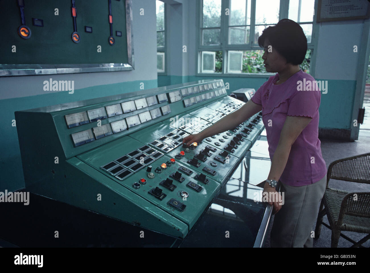 Chinese woman at control panel of Hydro electric plant in Chengdu ...
