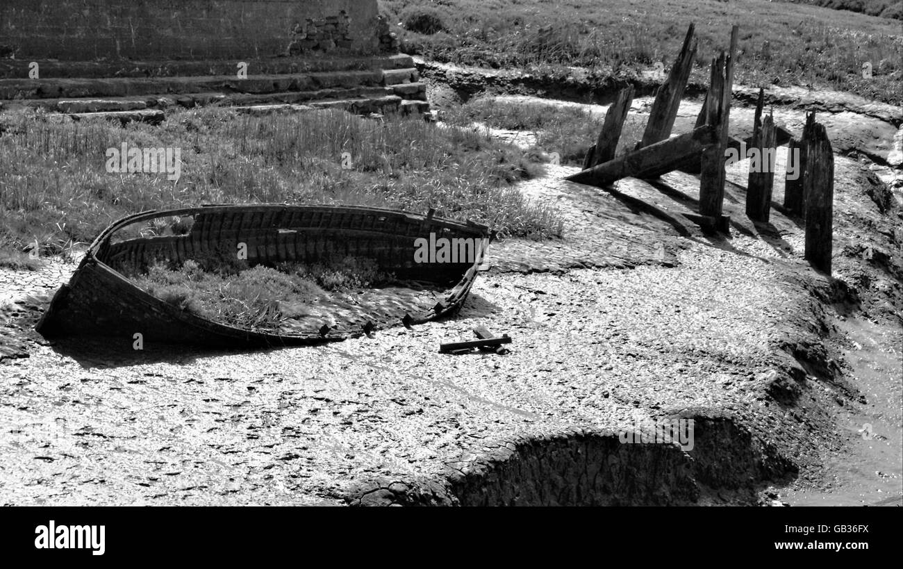 Old sunk fisher boat during tide out Stock Photo - Alamy