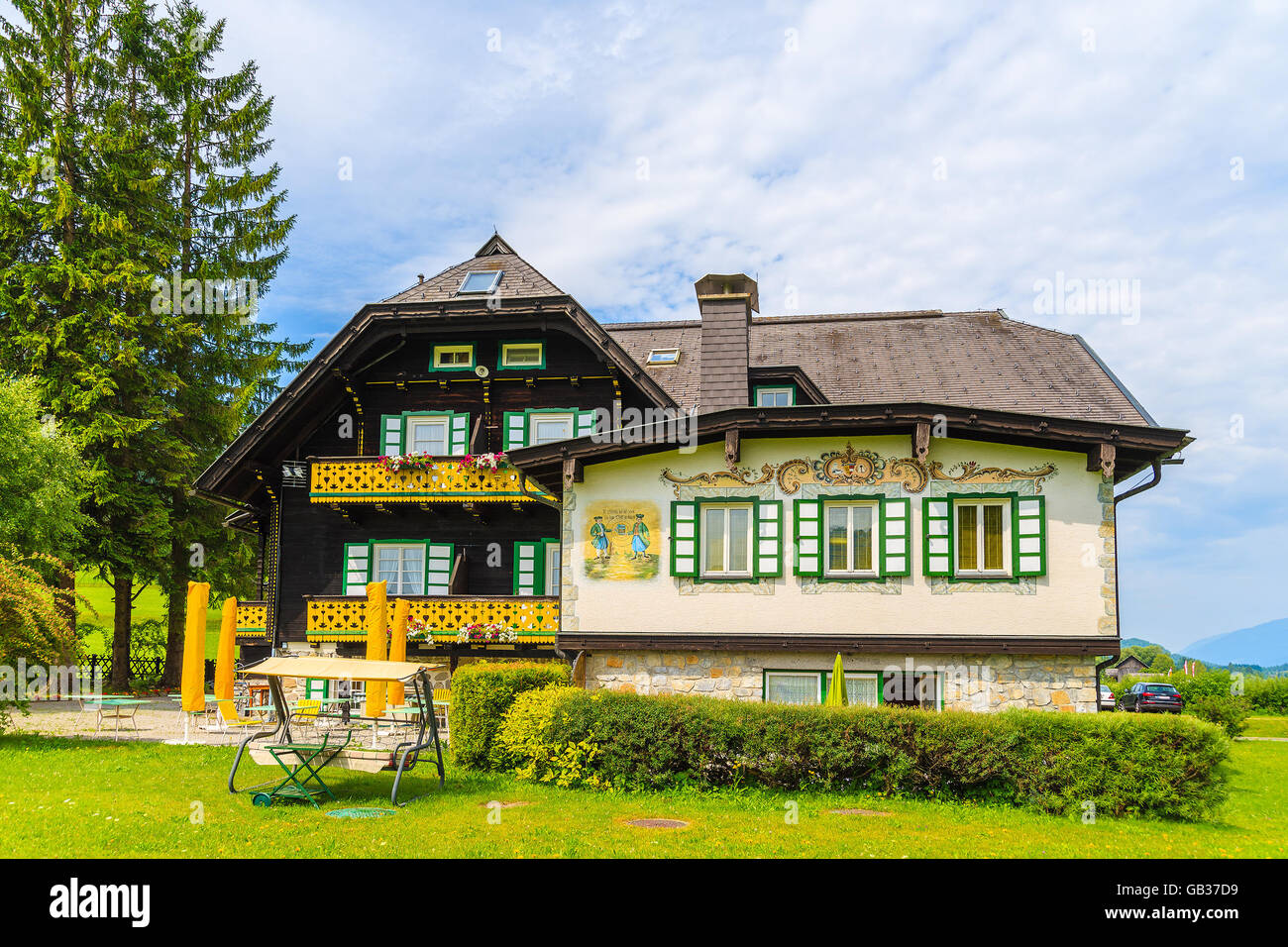 WEISSENSEE LAKE, AUSTRIA - JUL 6, 2015: Typical alpine guest house on ...