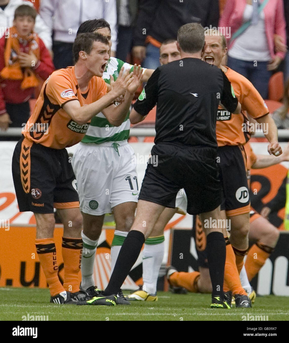 Dundee Utd players confront the referee Charlie Richmond after he ...