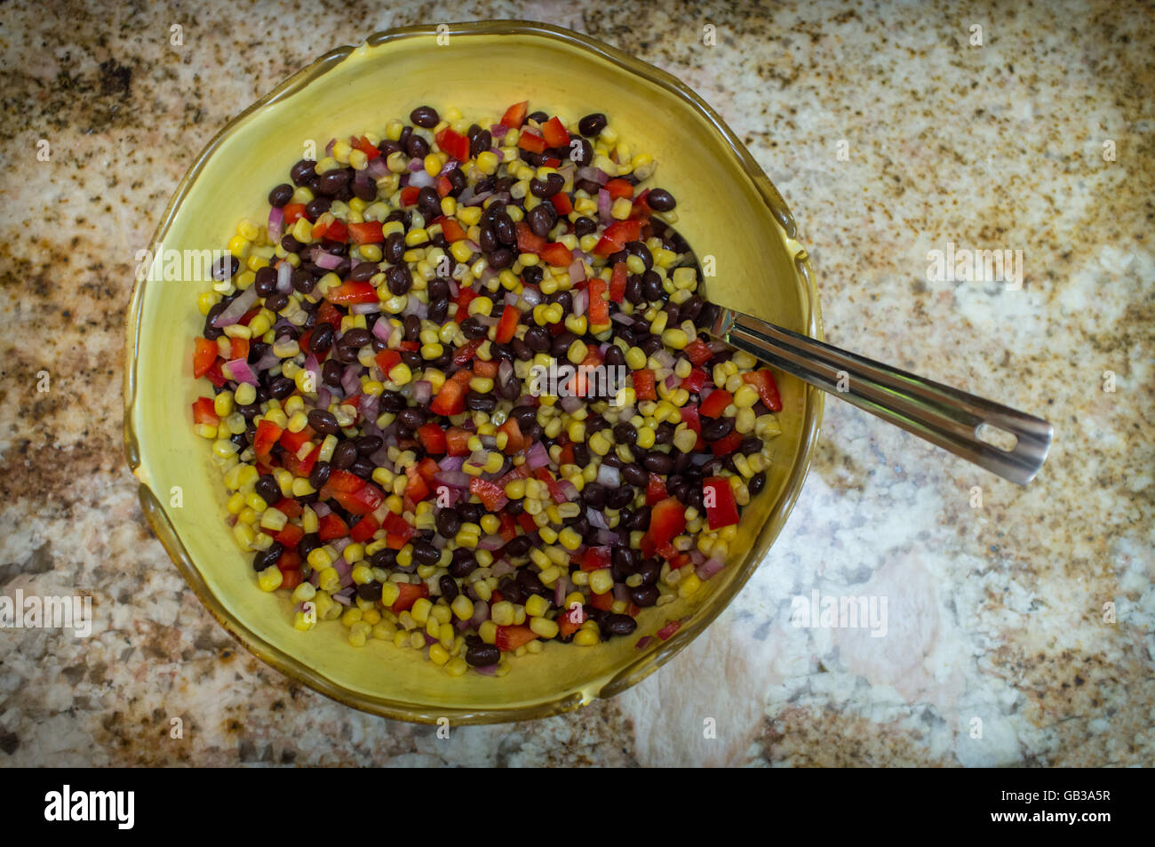 Mexican bean and corn salad salsa in giant yellow bowl Stock Photo - Alamy