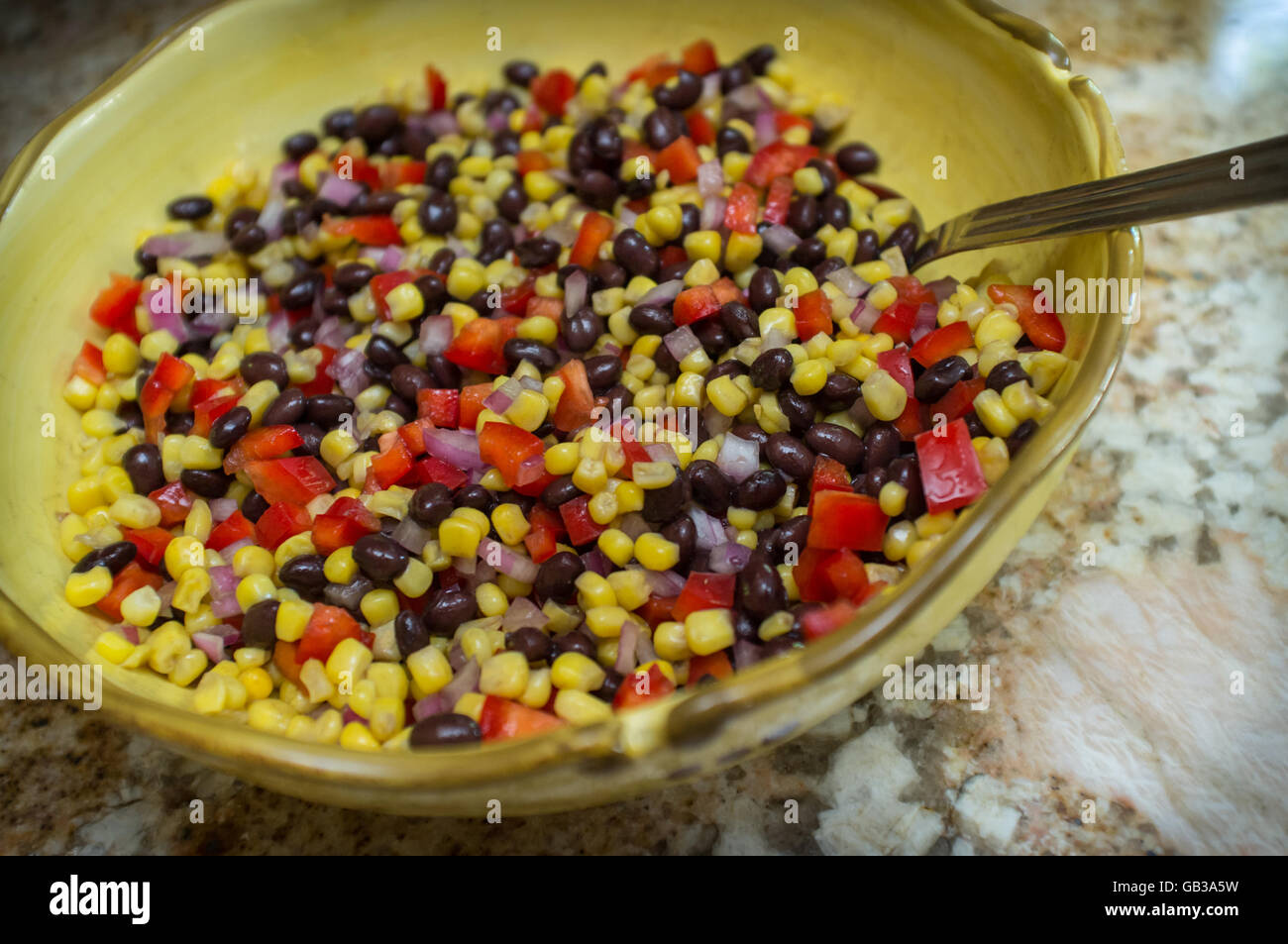 Mexican bean and corn salad salsa in giant yellow bowl Stock Photo - Alamy
