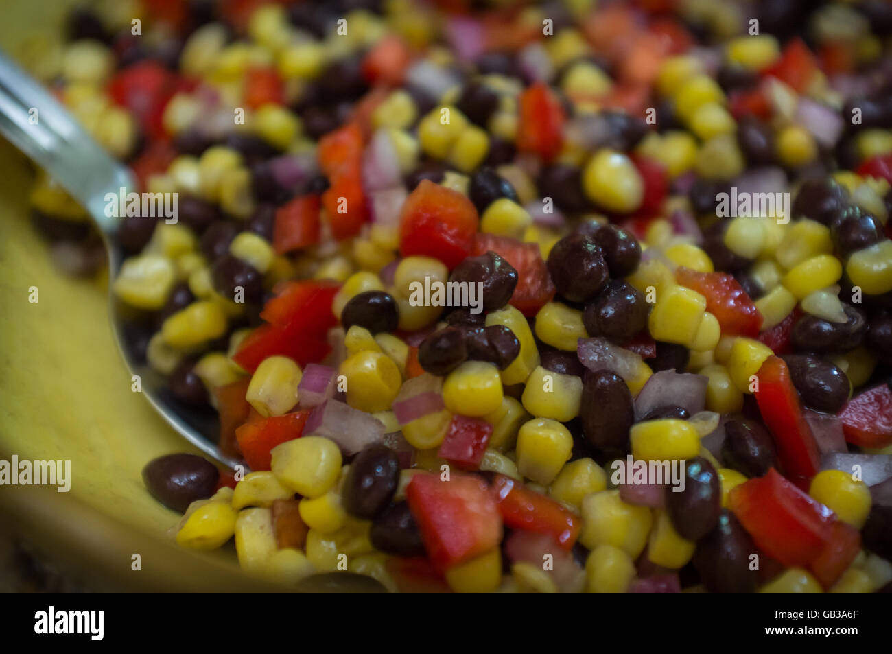 Mexican bean and corn salad salsa in giant yellow bowl Stock Photo - Alamy