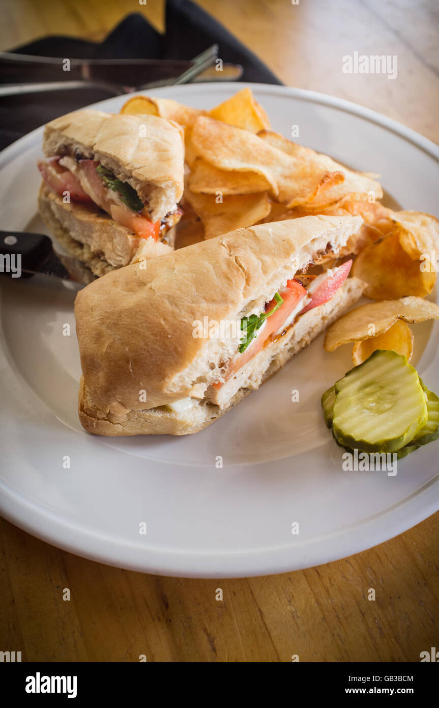 Grilled chicken panini with crispy home made chips Stock Photo - Alamy