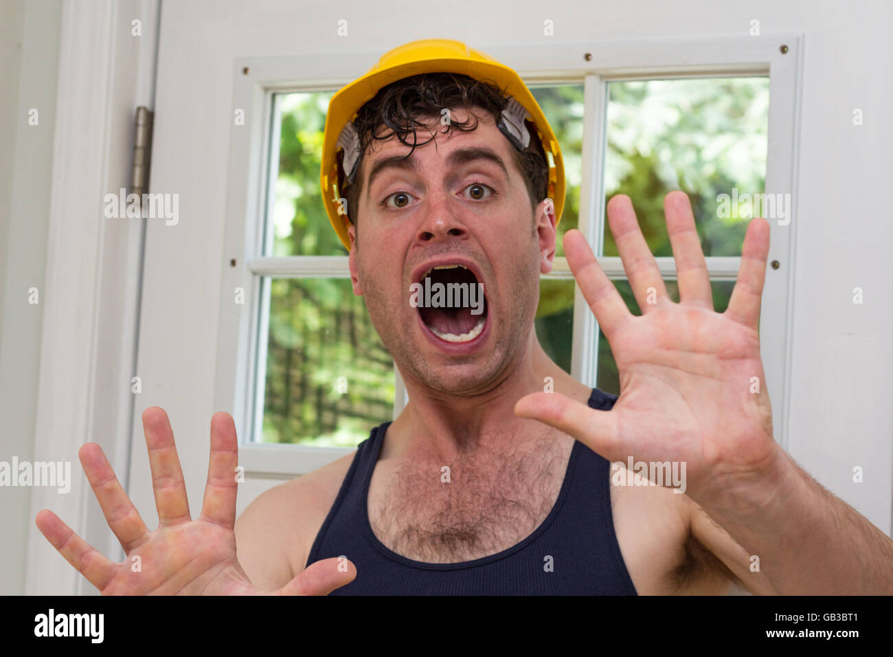 Young handsome construction worker in tank top and yellow hat Stock ...