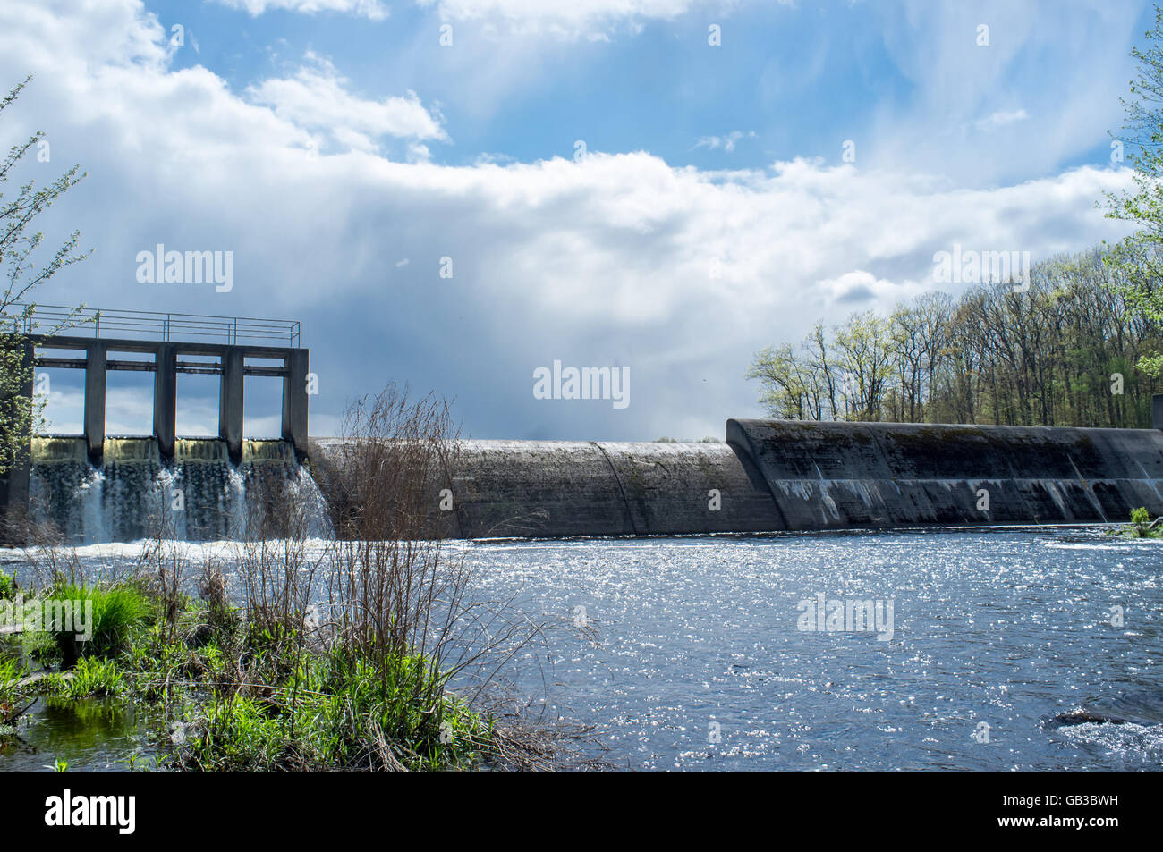 Overflowing man made damn at lake reservoir nature area Stock Photo - Alamy
