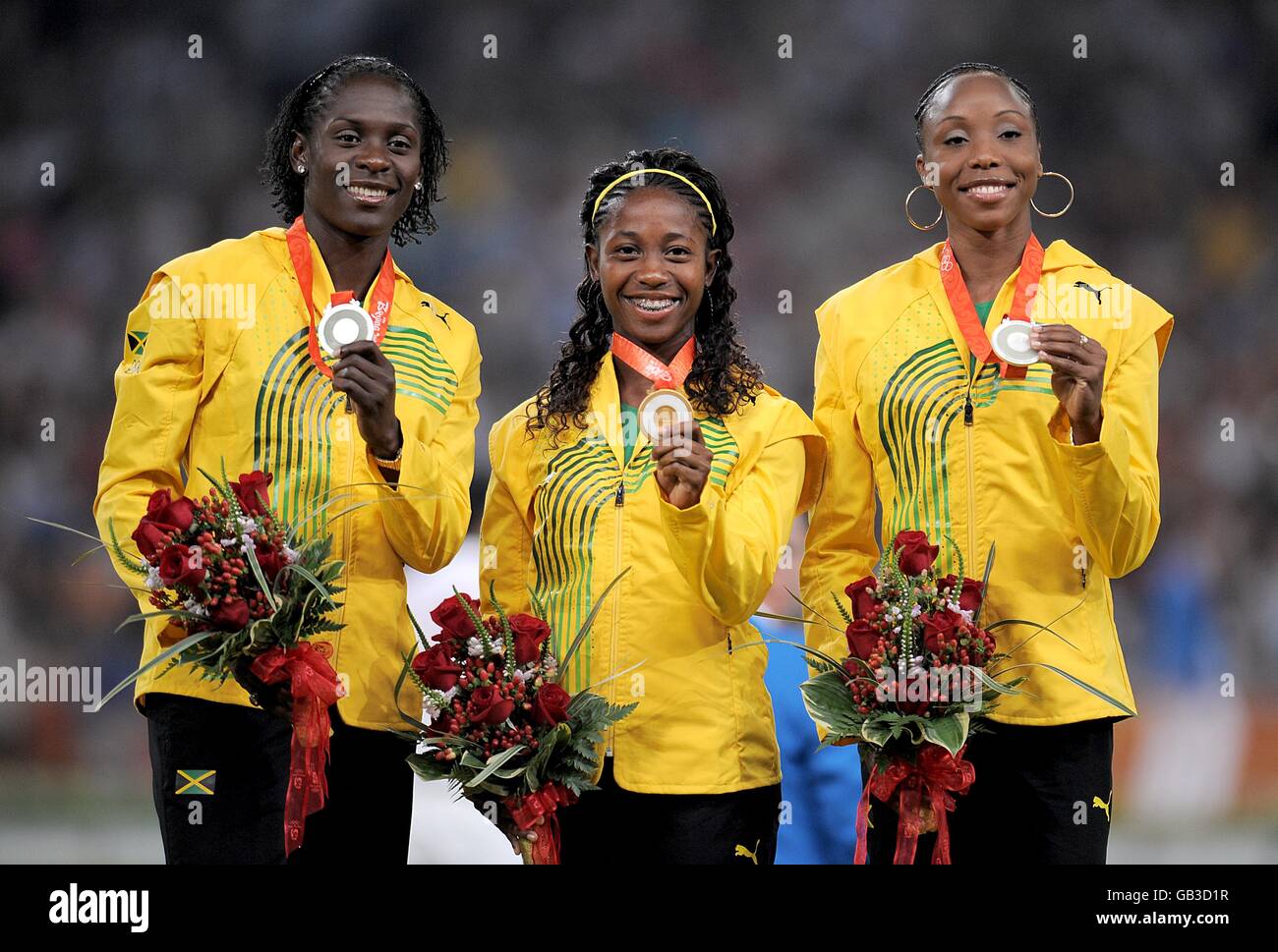 Jamaica's Shelly-Ann Fraser (centre) collects her gold medal for the ...