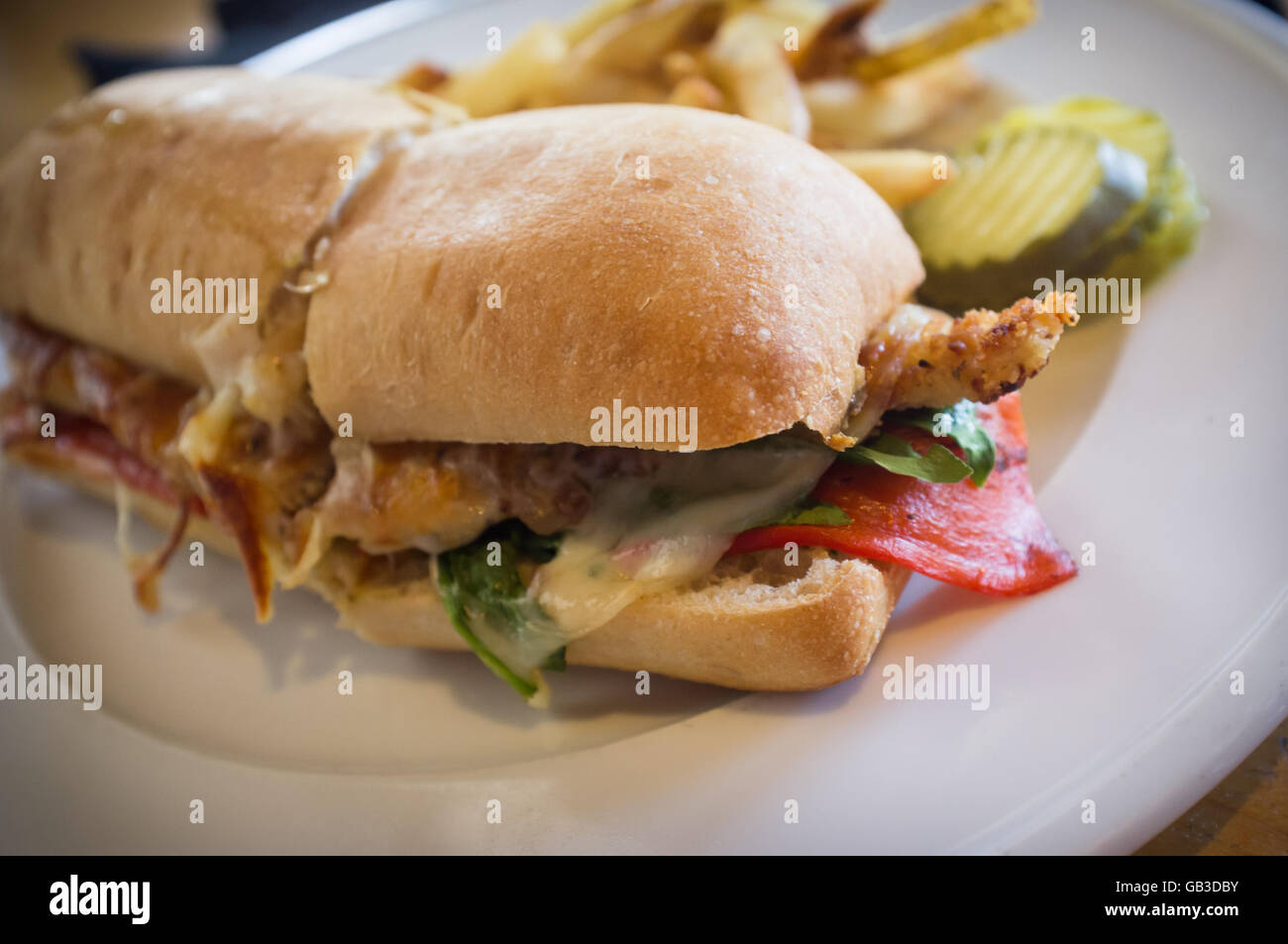 Grilled chicken panini with crispy side of fries Stock Photo - Alamy