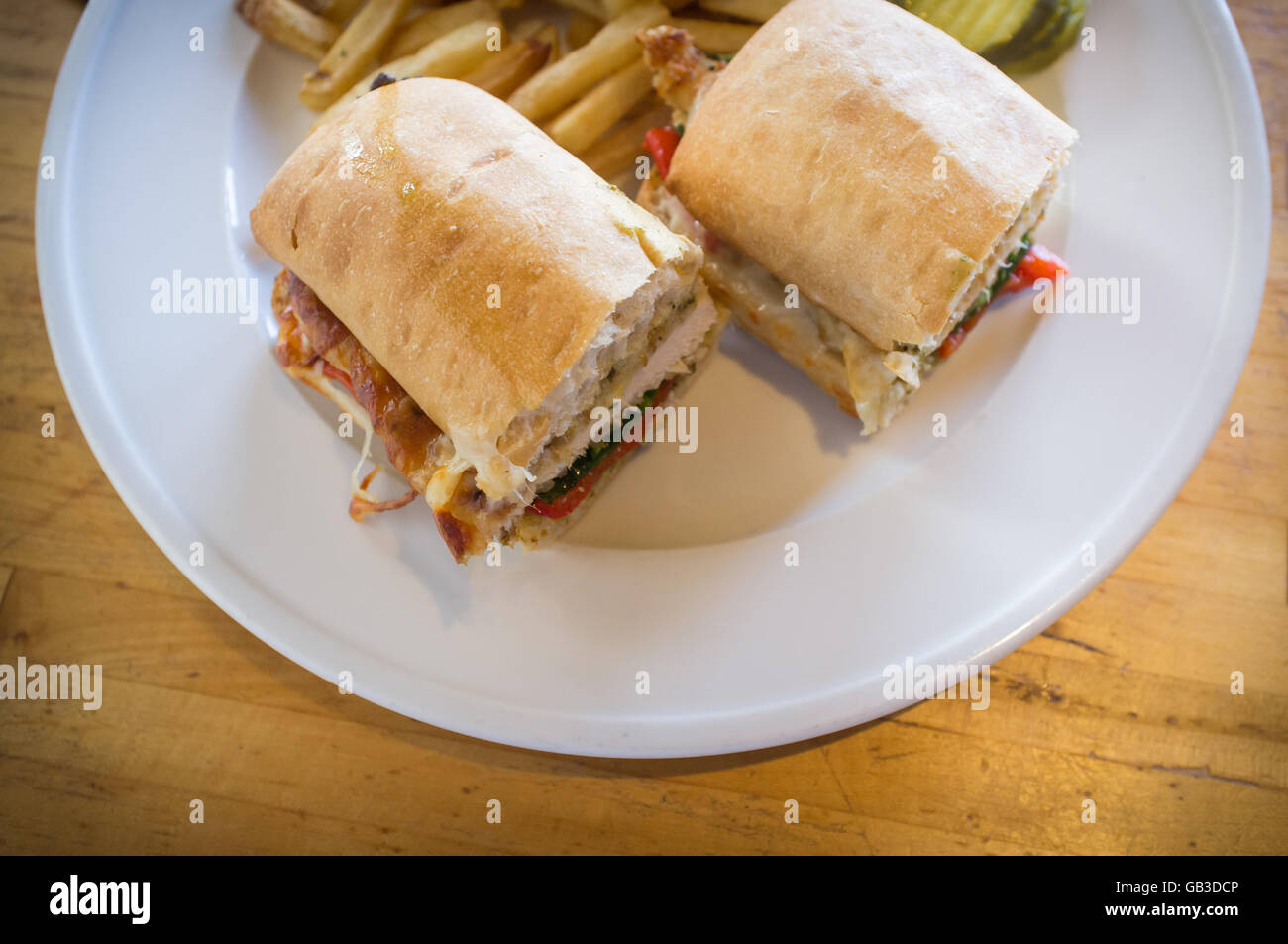 Grilled chicken panini with crispy side of fries Stock Photo - Alamy