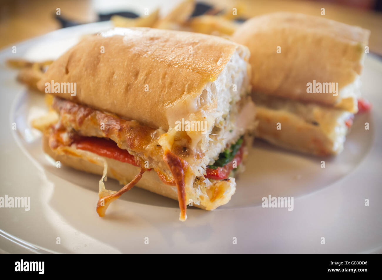 Grilled chicken panini with crispy side of fries Stock Photo - Alamy