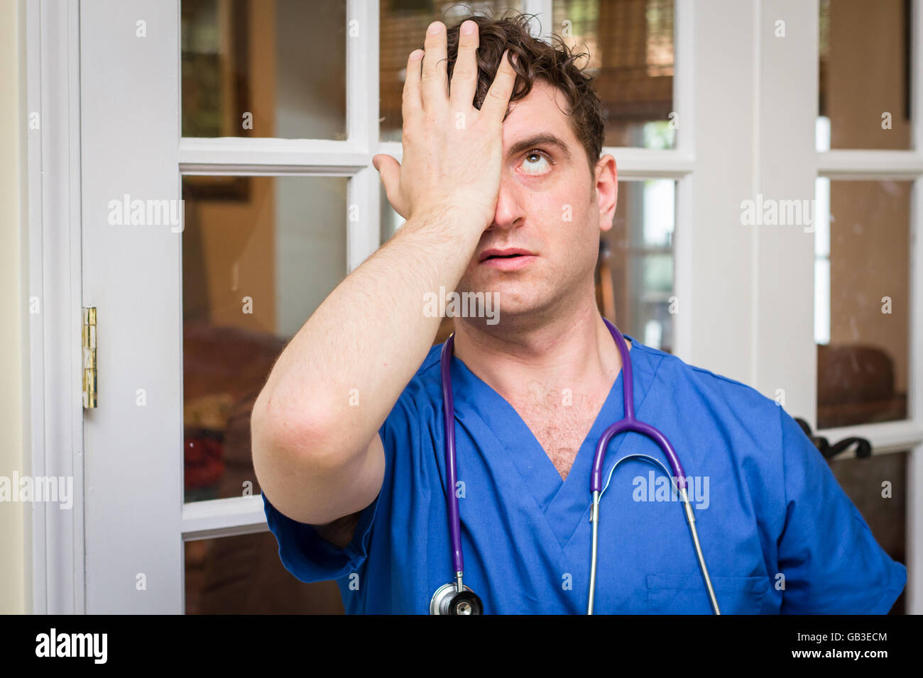 Male nurse in scrubs with stethoscope makes huge mistake Stock Photo ...