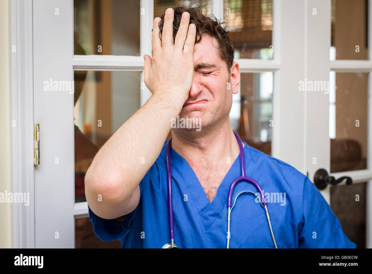 Male nurse in scrubs with stethoscope makes huge mistake Stock Photo ...