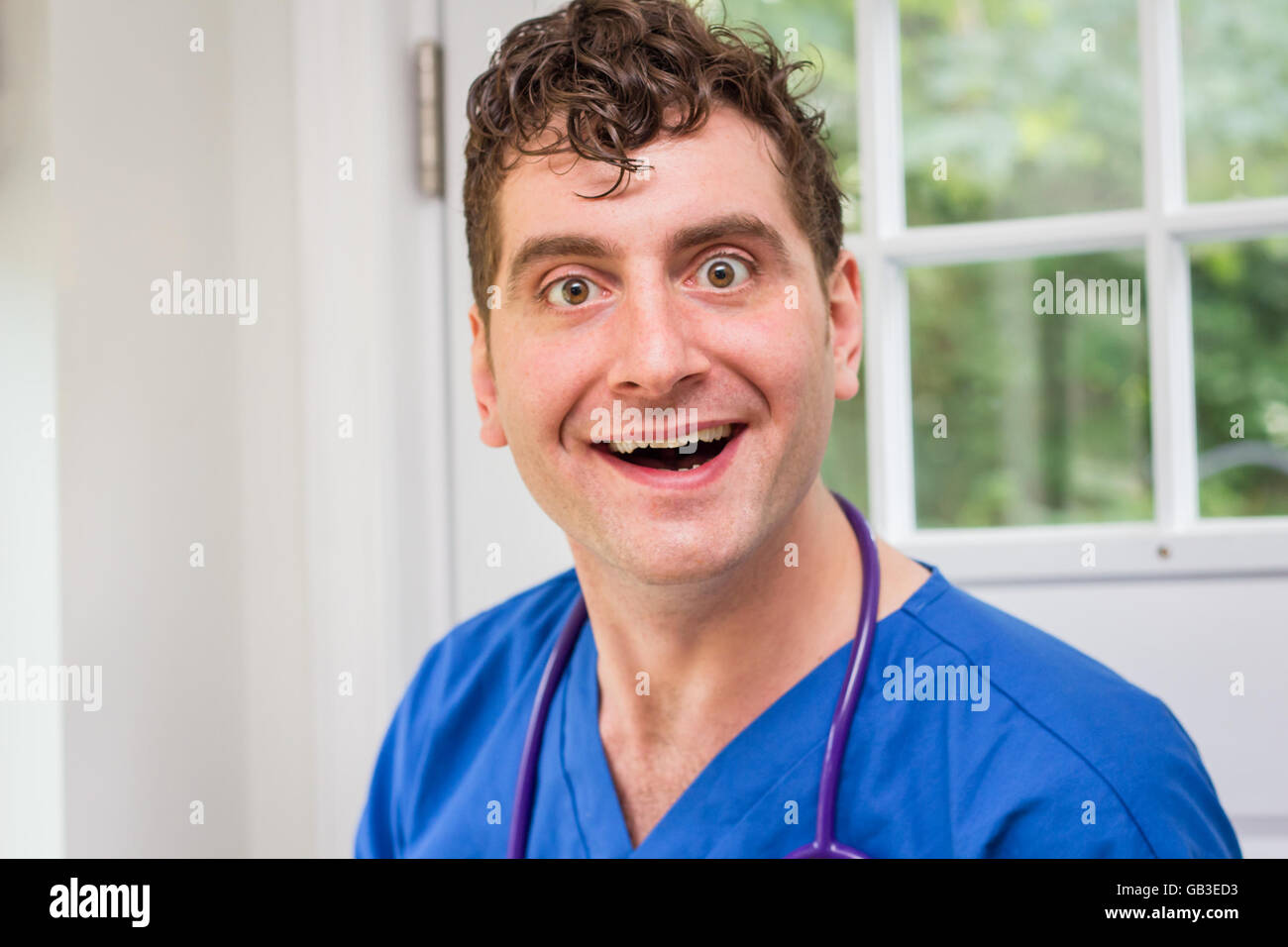 Male nurse in scrubs with stethoscope smiling like an idiot Stock Photo ...