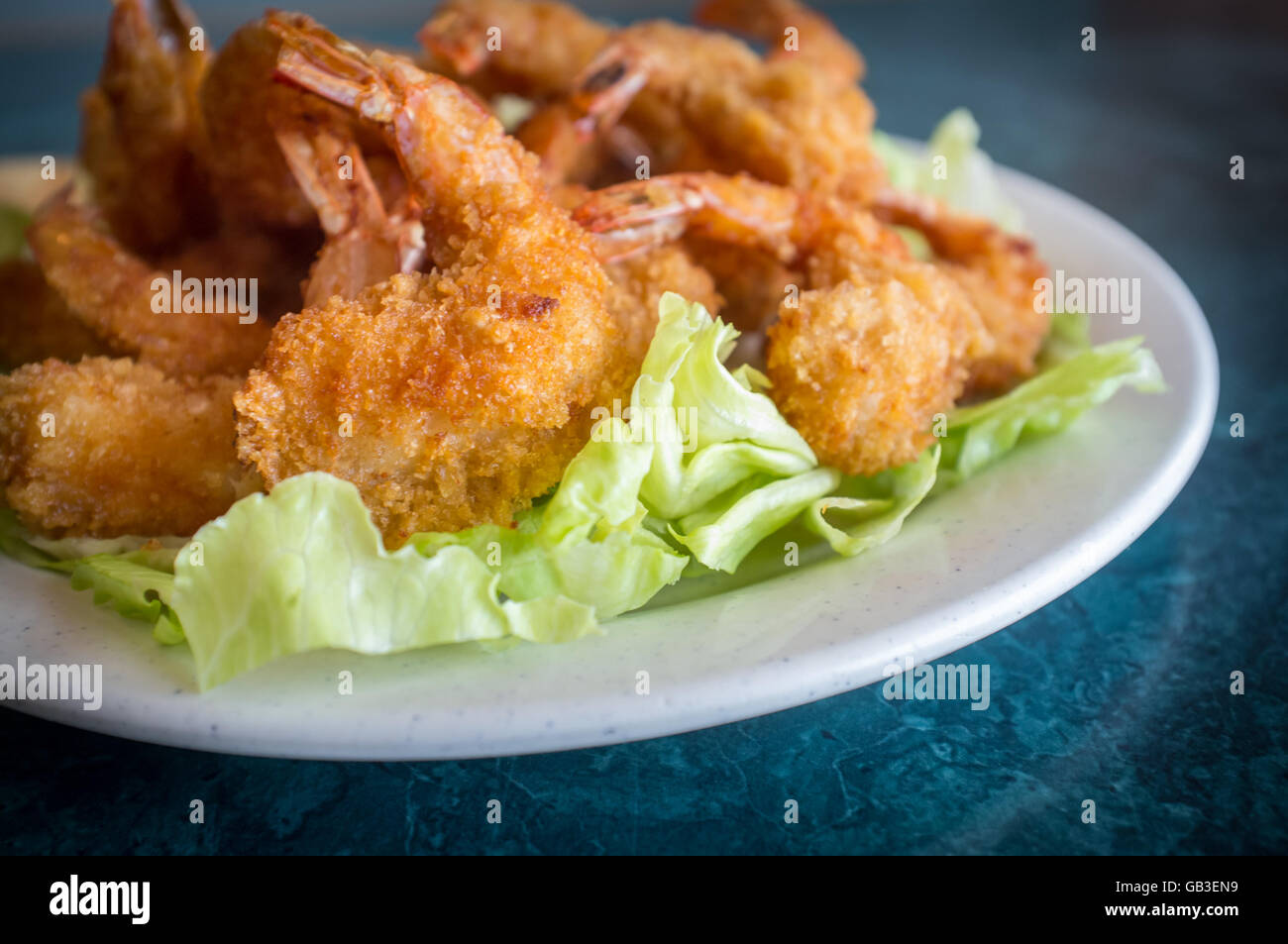 Large serving of popcorn shrimp tempura appetizer on bed of lettuce ...