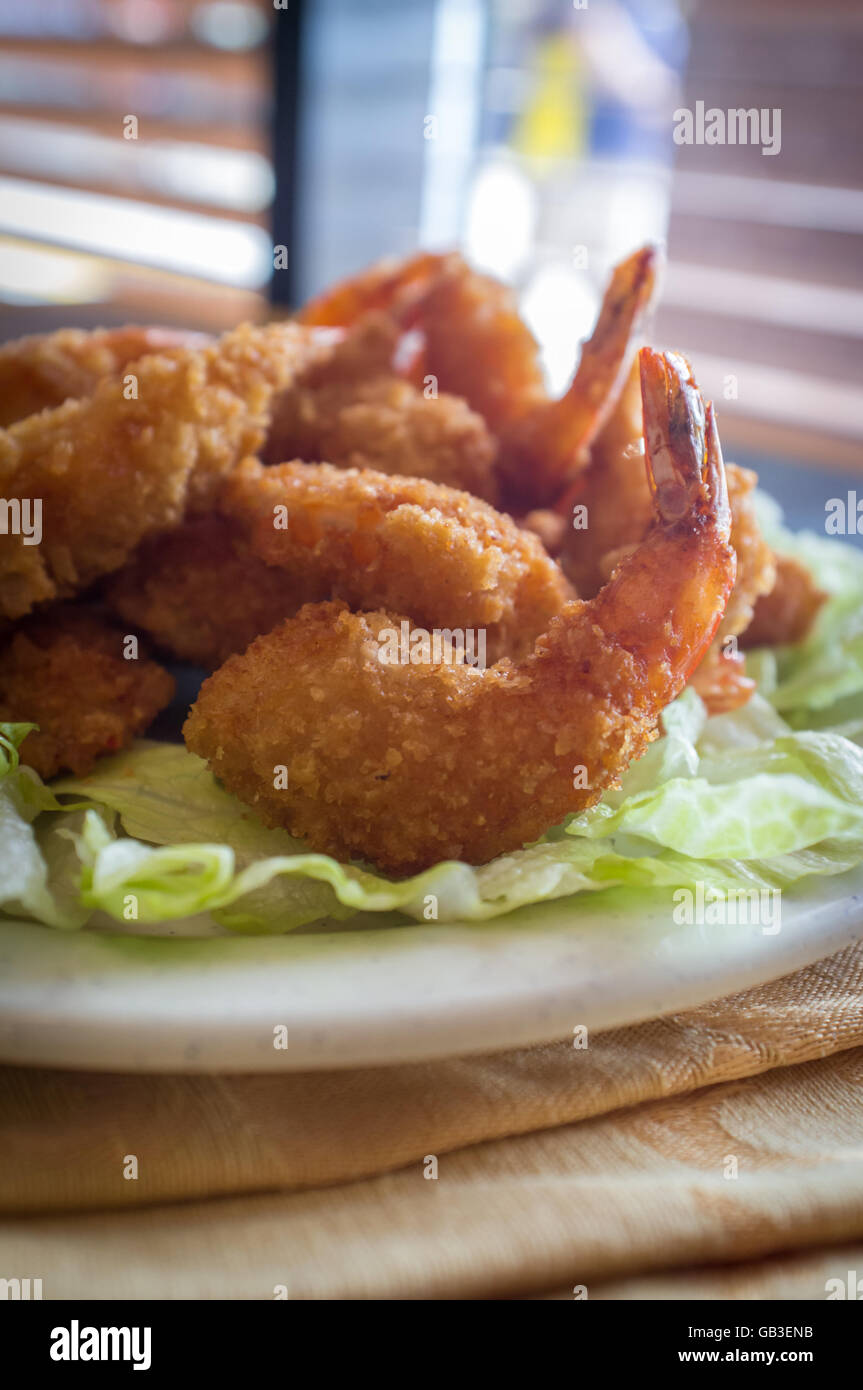 Large serving of popcorn shrimp tempura appetizer on bed of lettuce ...