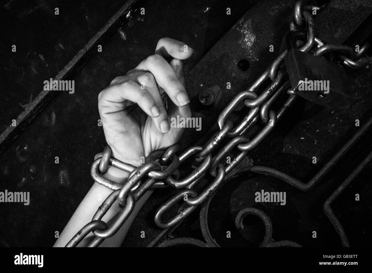 A woman's hand enchained Stock Photo - Alamy