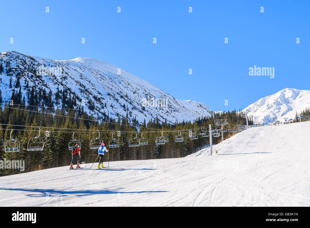 Alpine skiers on slope in Rohace winter resort, Tatra Mountains ...
