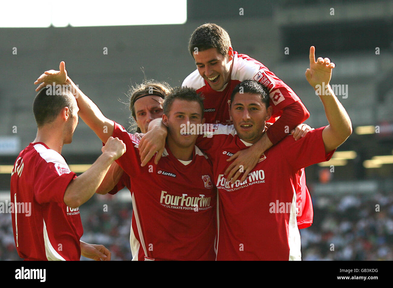 Swindon Town's players celebrate their 1st goal scored by number Billy ...