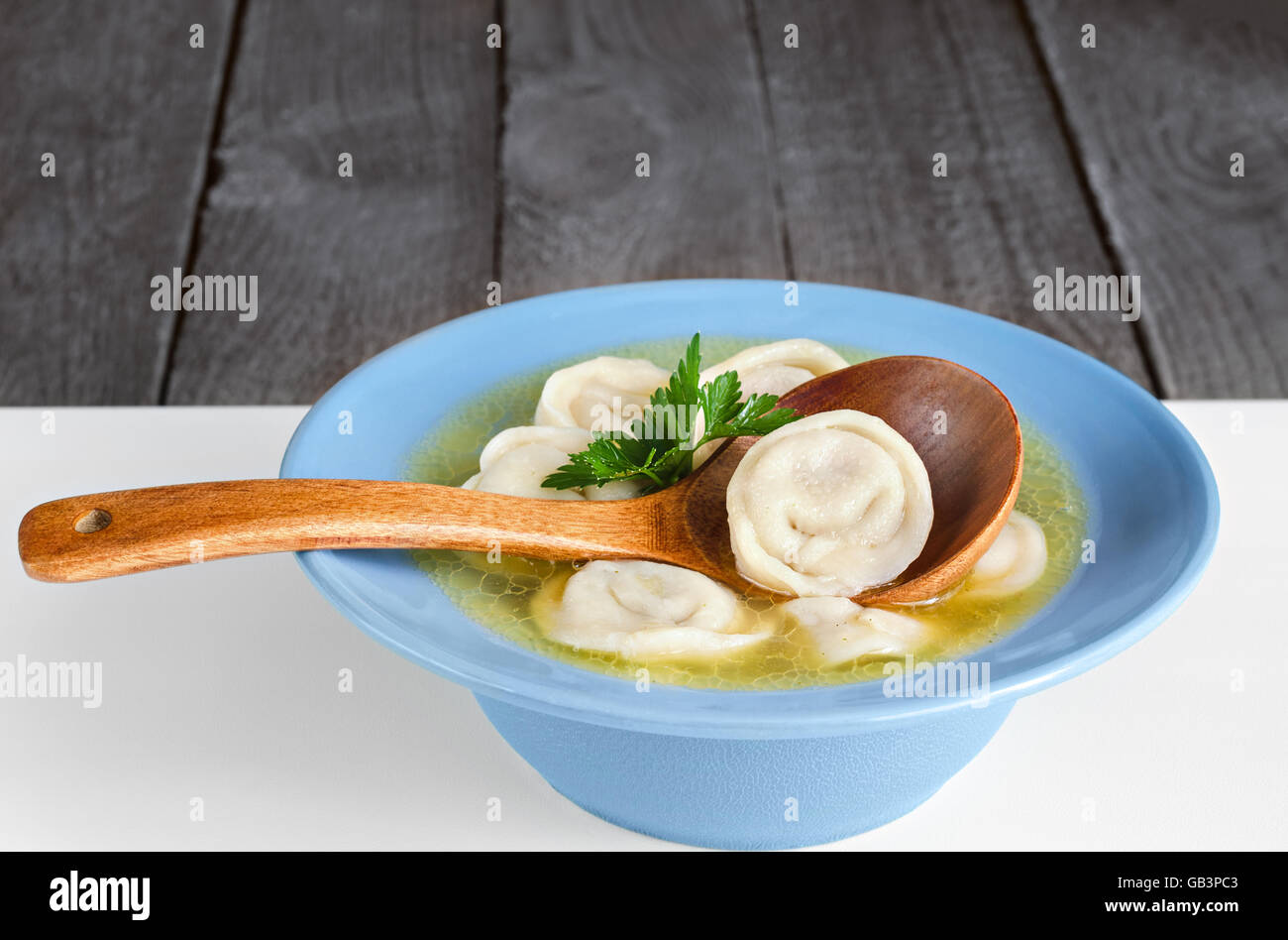 Dumplings in a bowl and wooden spoon Stock Photo - Alamy