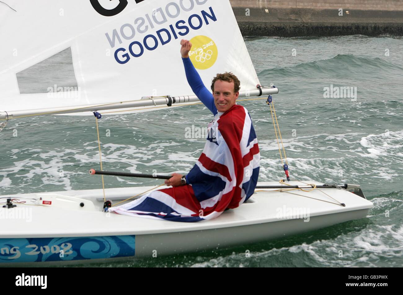 Great Britain's Paul Goodison celebrates as he is towed back in to port ...