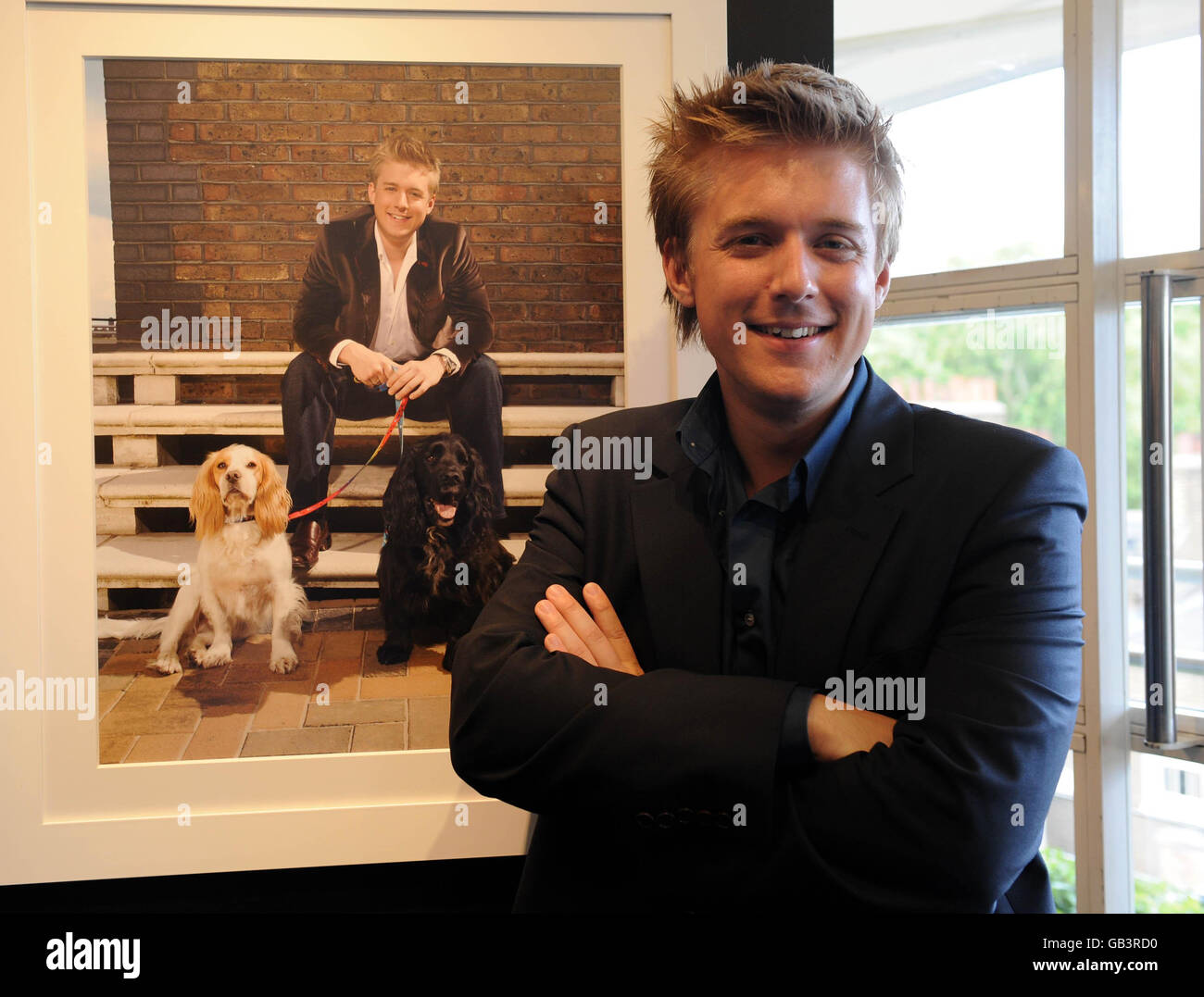 Jonathan Ansell is seen with his portrait from the new PDSA Pet ...