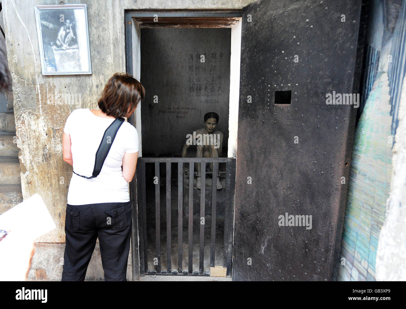 A tourist views a reconstruction of a cell commonly known as a tiger ...