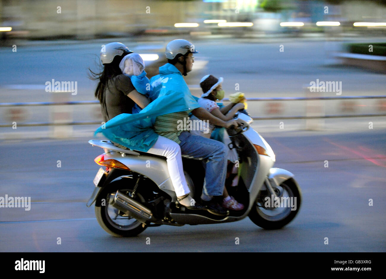 Four people share a single motorcycle in Ho Chi Minh City, Vietnam ...