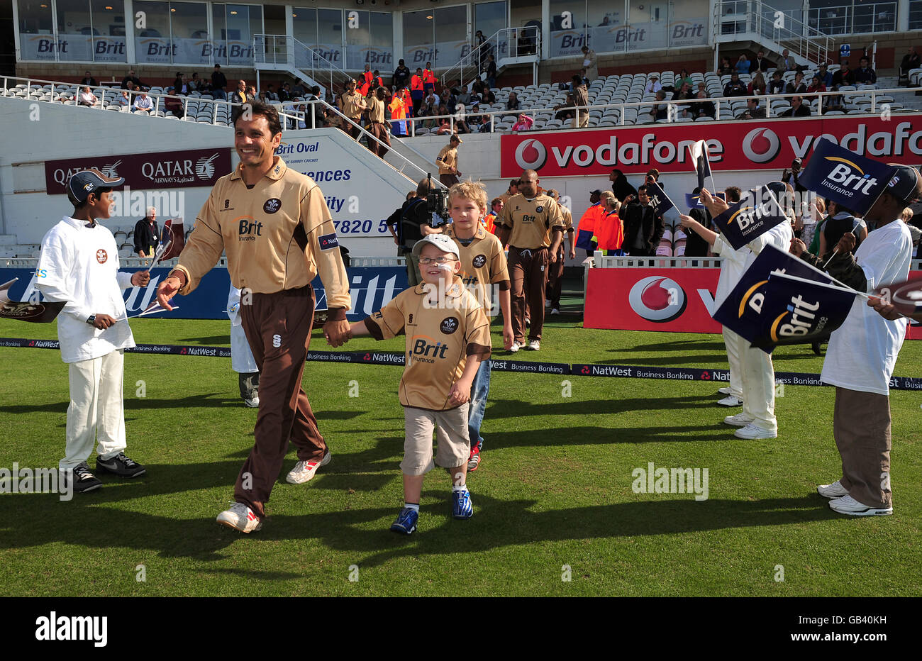 Surrey's Mark Ramprakash leads his players out through the Guard of ...