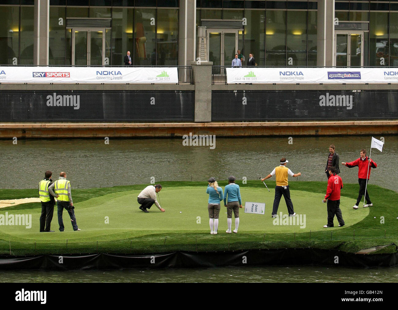 Golfers play on a floating golf course at South Dock, Canary Wharf ...