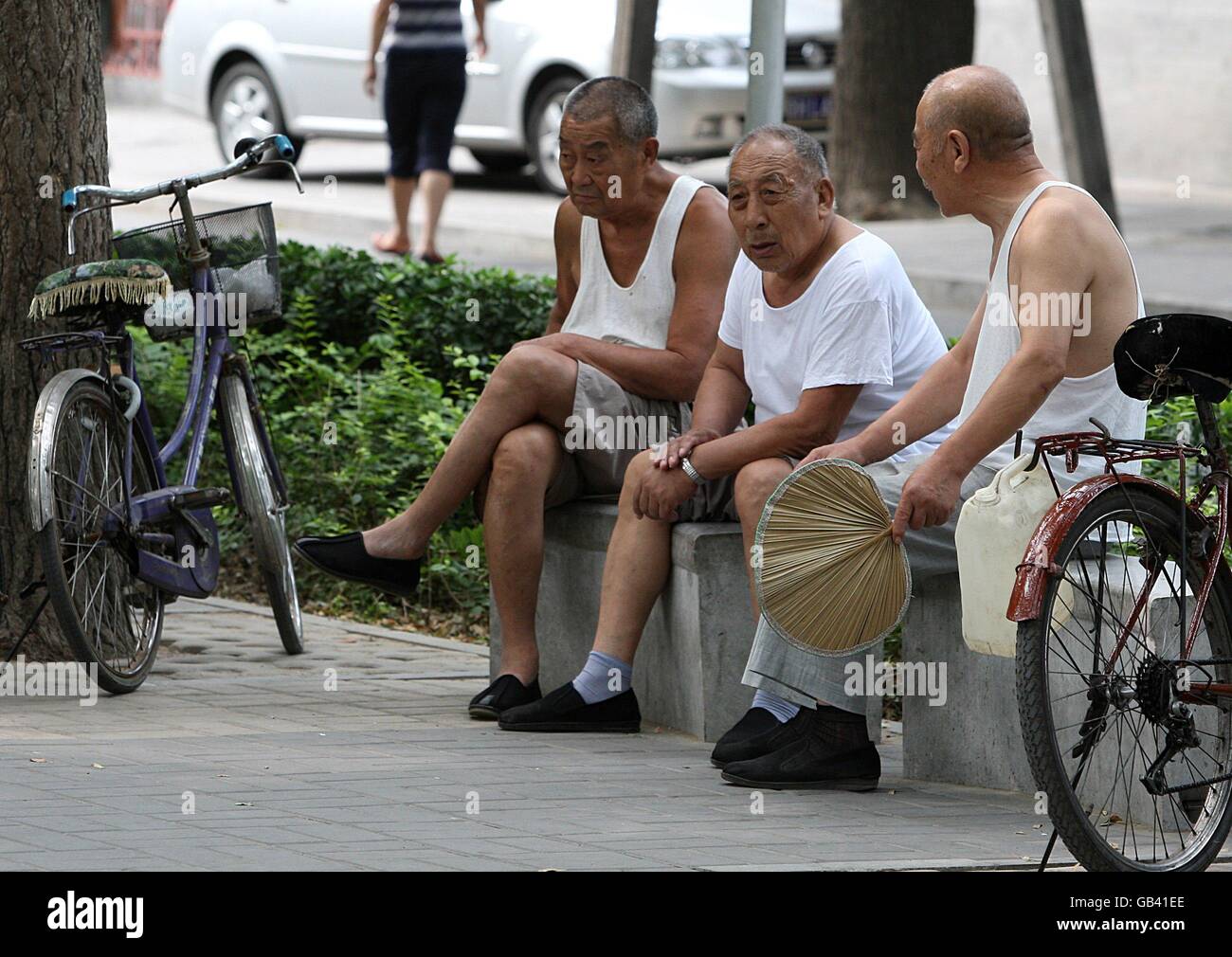 Three chinese men sit talking in beijing hi-res stock photography and ...
