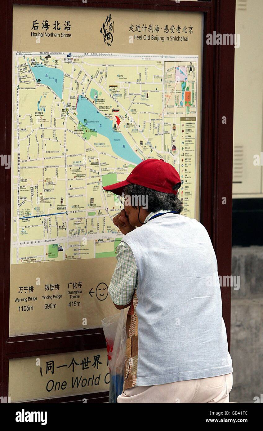Olympics - Beijing Olympic Games 2008. A woman inspects a map of ...