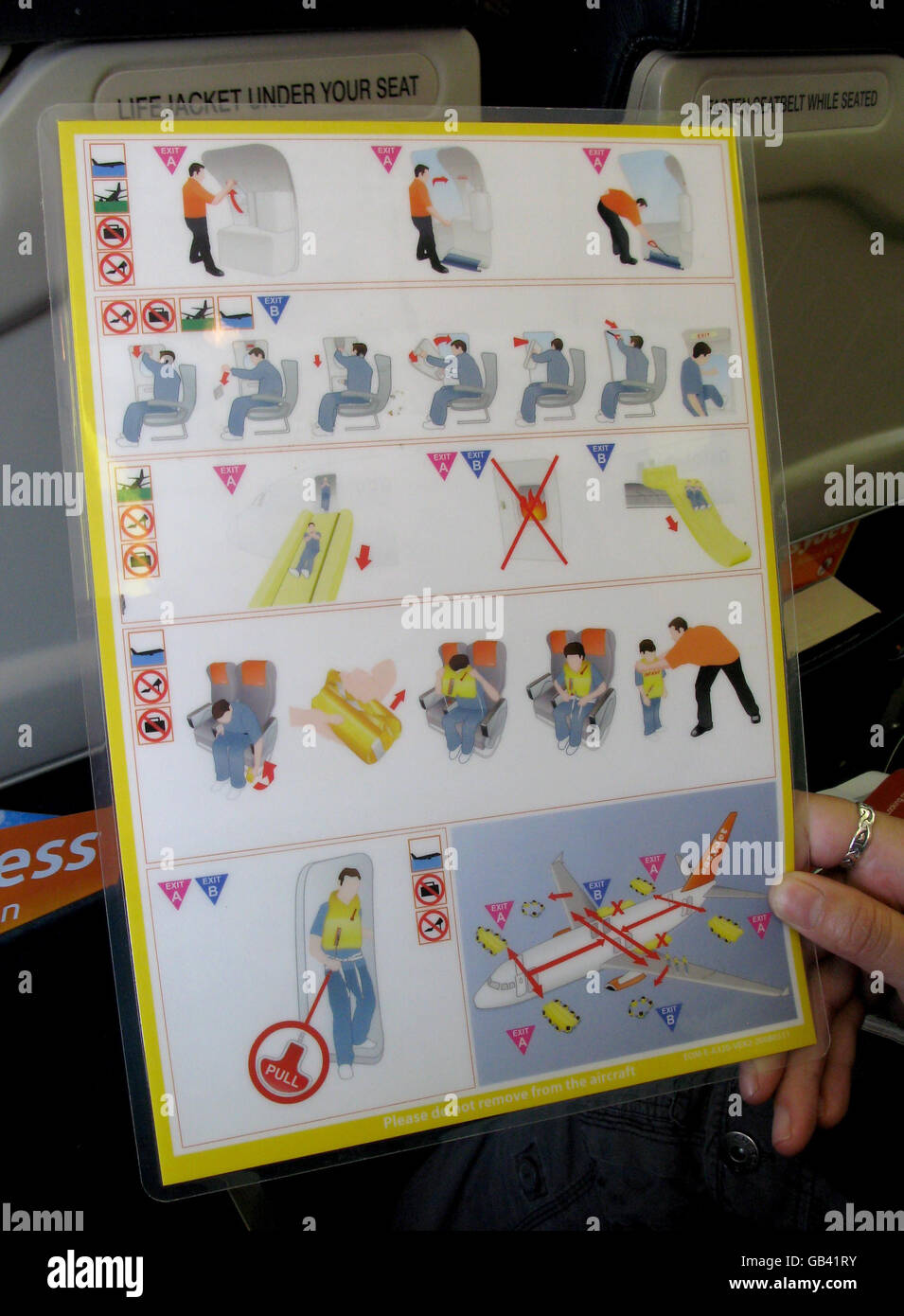 Generic stock picture of a passenger reading the safety information on ...