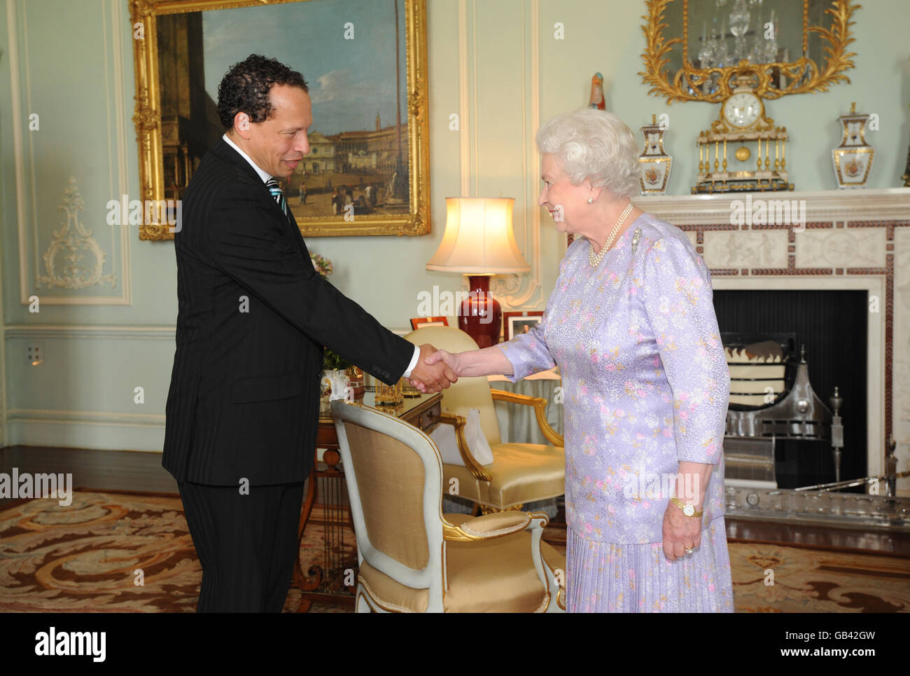 The Queen shakes hands with Lawrence Hill the winner of the writers ...