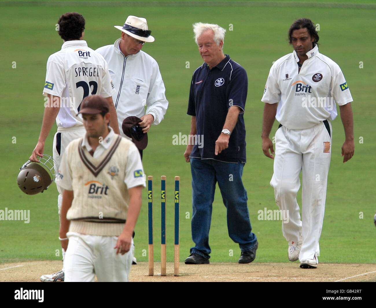 Surrey's head groundsman Bill Gordon (centre right) and match umpire ...