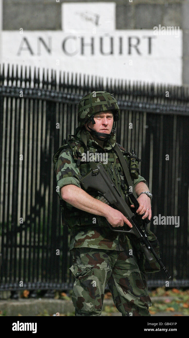 Irish Defence Forces provide security as five men arrested at a ...