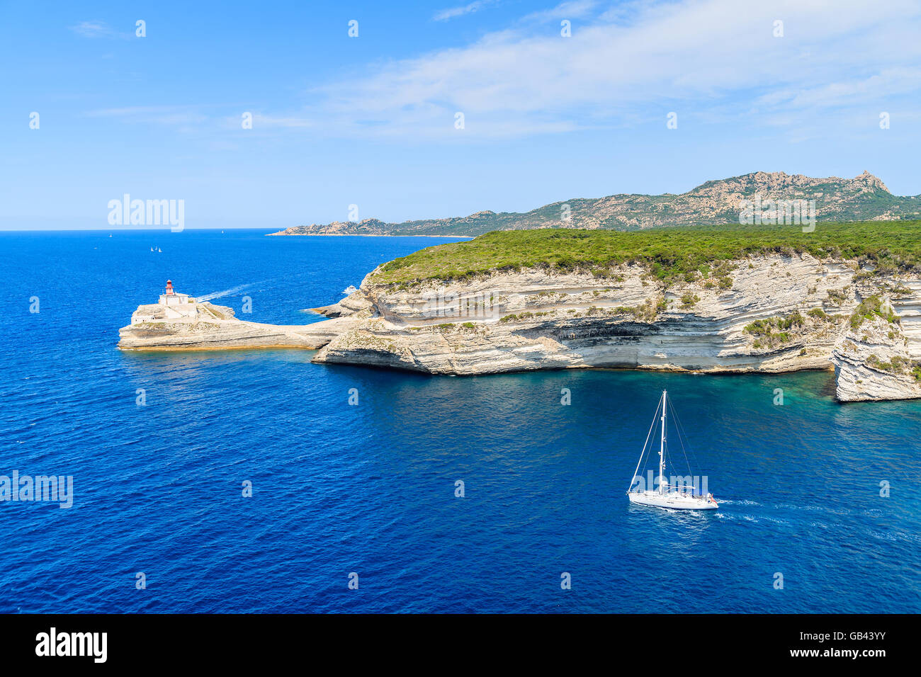 Yacht boat sailing out from Bonifacio port out to open sea, Corsica ...