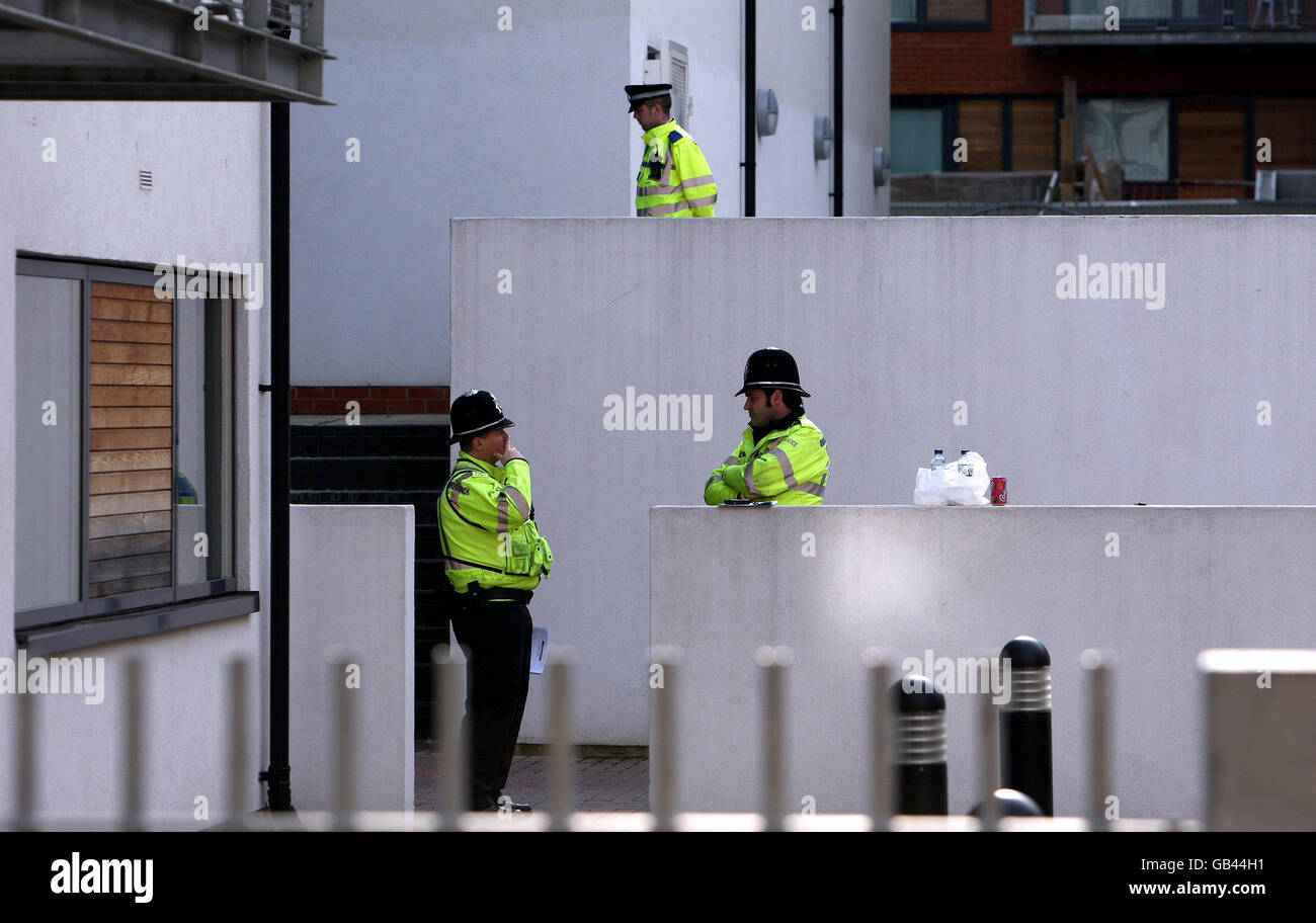 Police stand outside an apartment block in Ladywood, Birmingham, after ...
