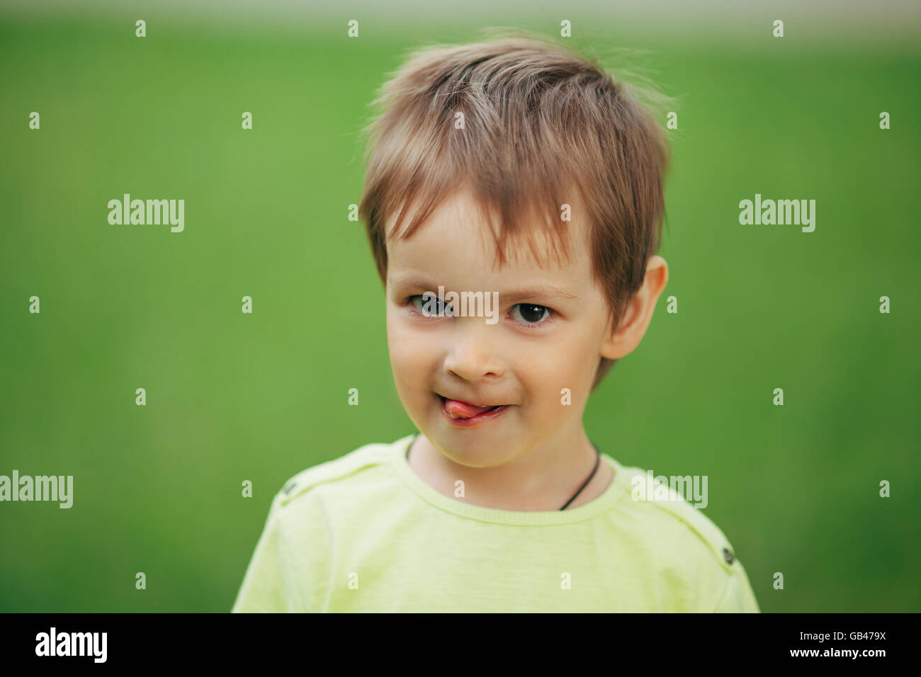 little boy on green background Stock Photo - Alamy