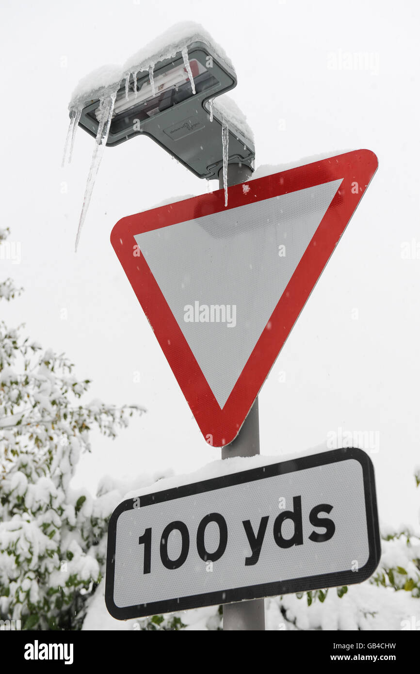icicles dripping from a light above a 100 yard street sign warning ...