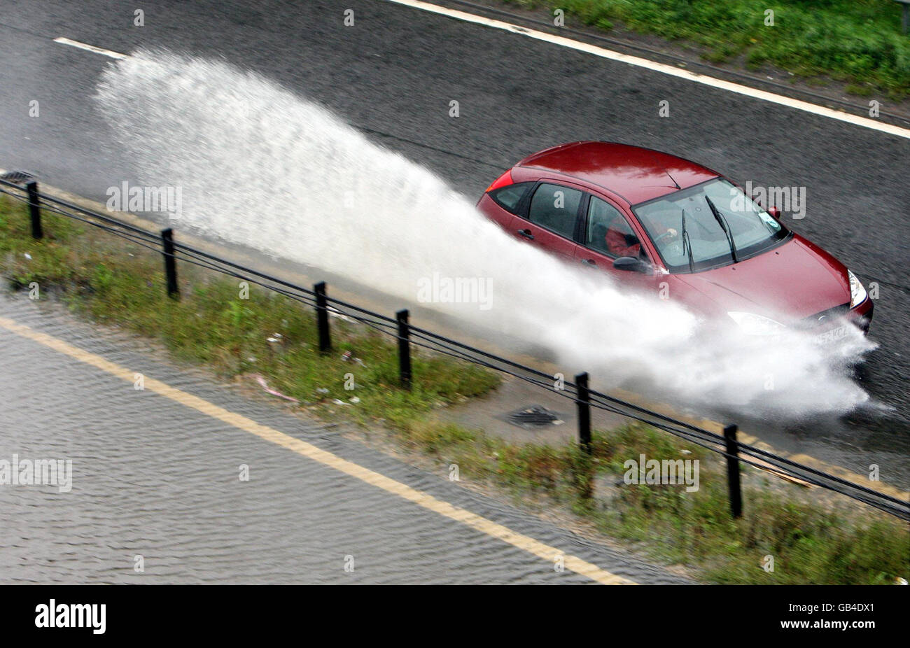 A car drives through flood water on the A167 in Newcastle, where heavy ...