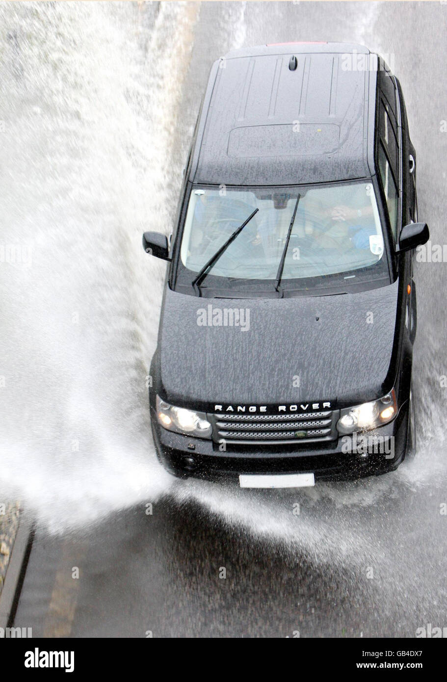 A car drives through flood water on the A167 in Newcastle, where heavy ...