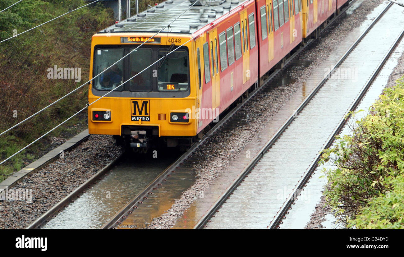 A metro train slowly travels along the flooded track's at Wardley in ...