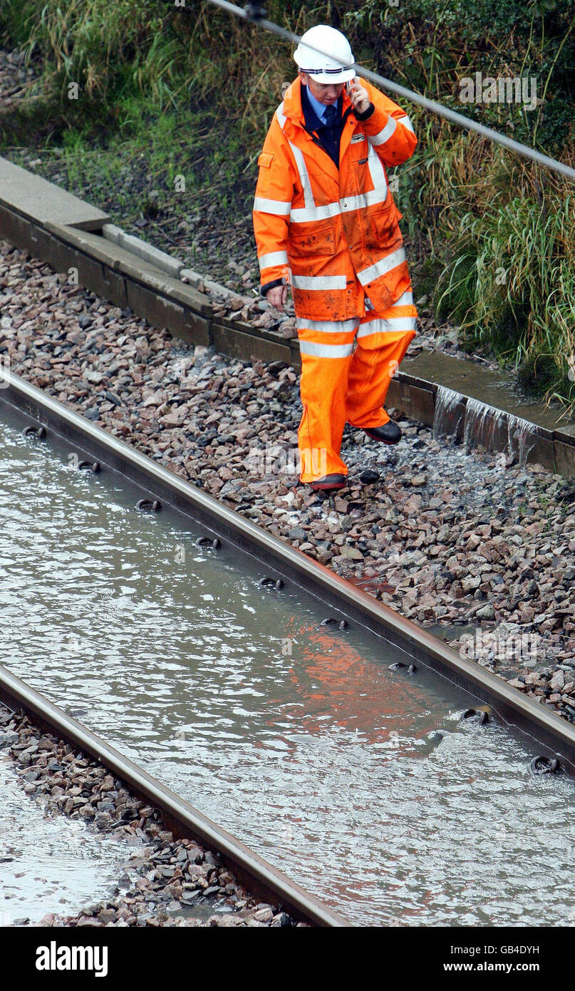 A Network Rail Inspector, checking flooded track' as a metro train ...
