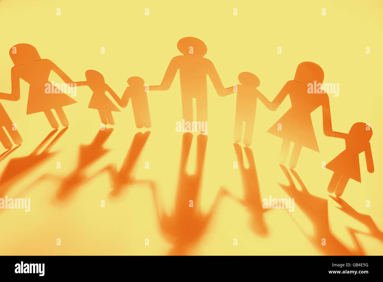 Family paper chain cutout holding hands Stock Photo - Alamy