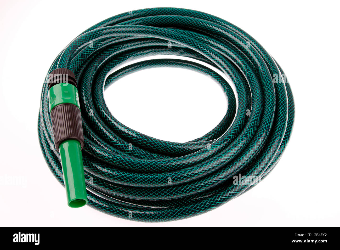 Garden hose coiled on plain background Stock Photo - Alamy