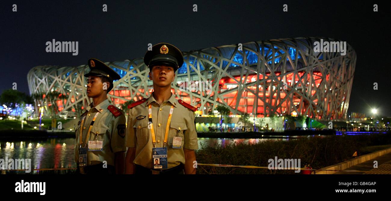 Chinese security officials stand guard in front of the National Stadium ...