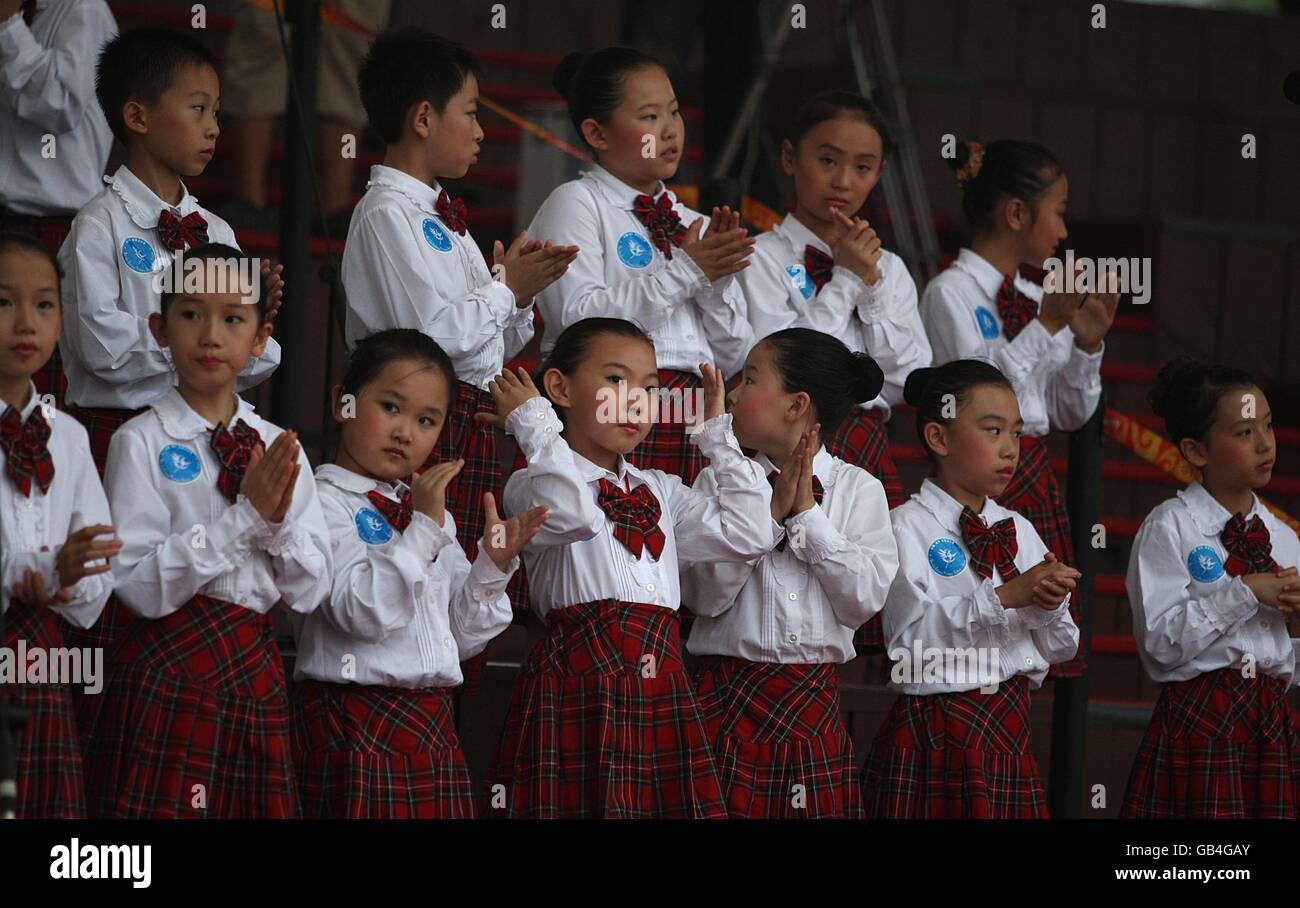 Chinese children perform during the flag raising ceremony at the ...